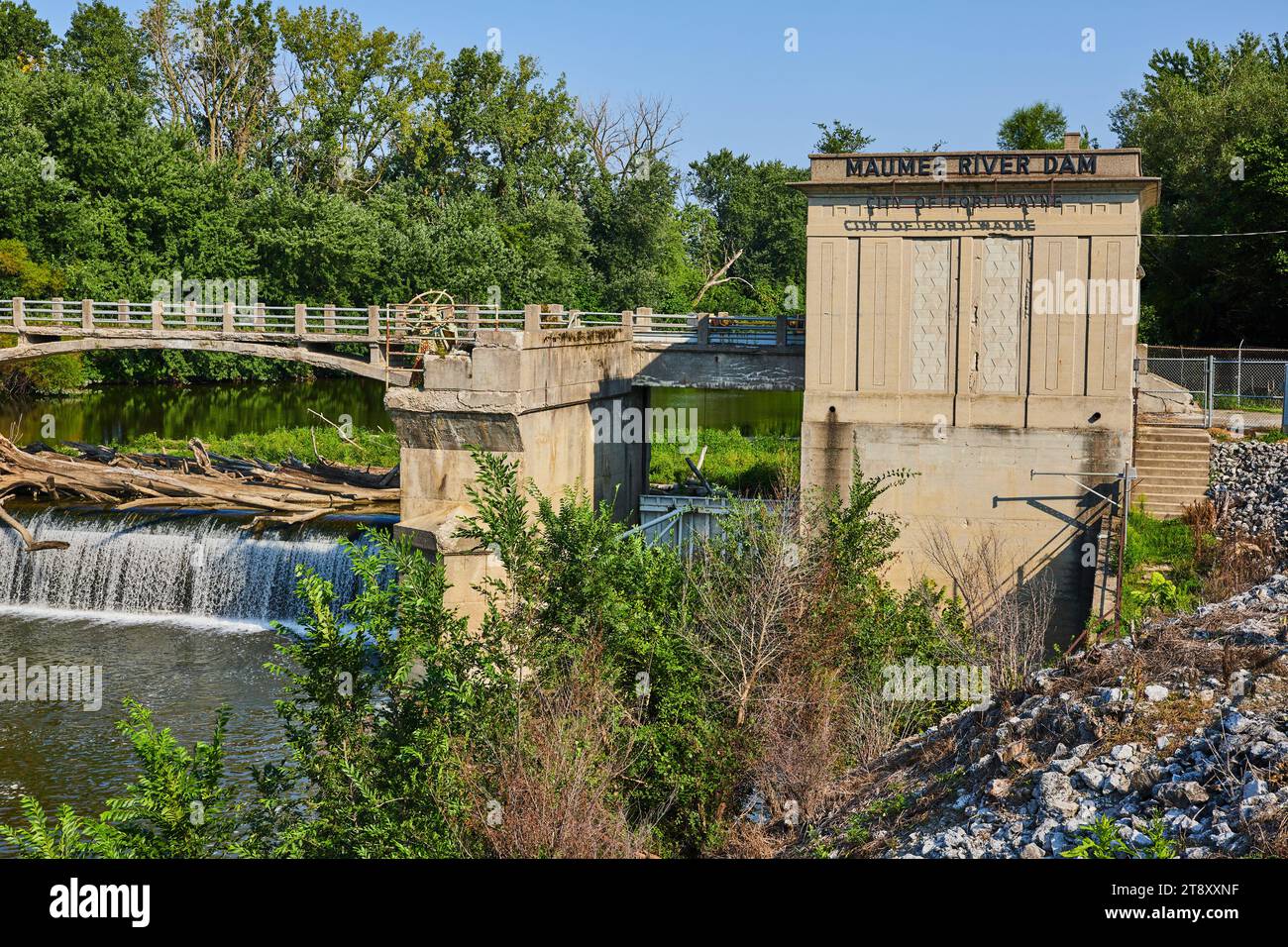 Maumee River Dam sign on building with logs overflowing top of ...