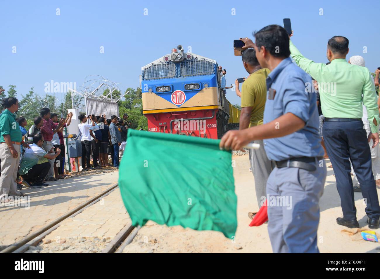 Indian people looking at a trial train and taking photographs, which is ...
