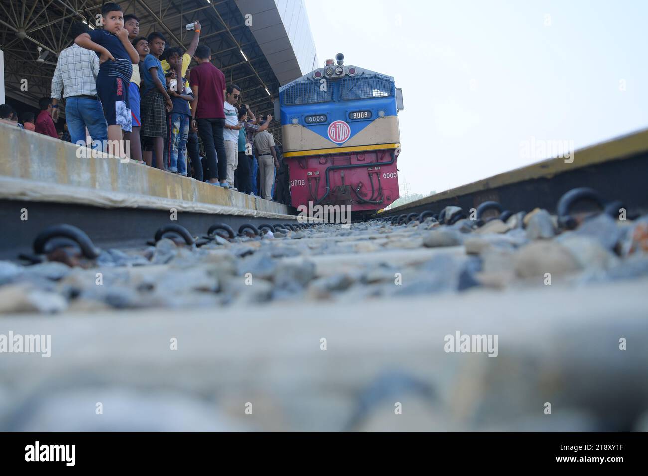 Indian people looking at a trial train and taking photographs, which is ...
