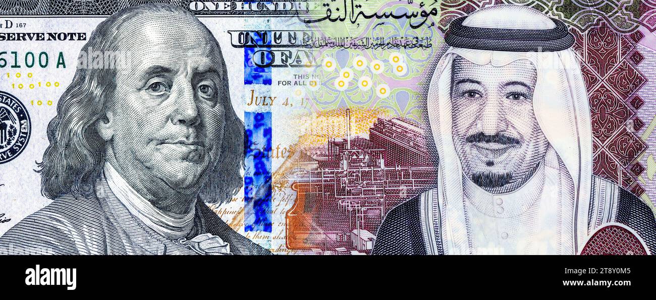 American dollars with Benjamin Franklin and Saudi Arabia banknote with ...