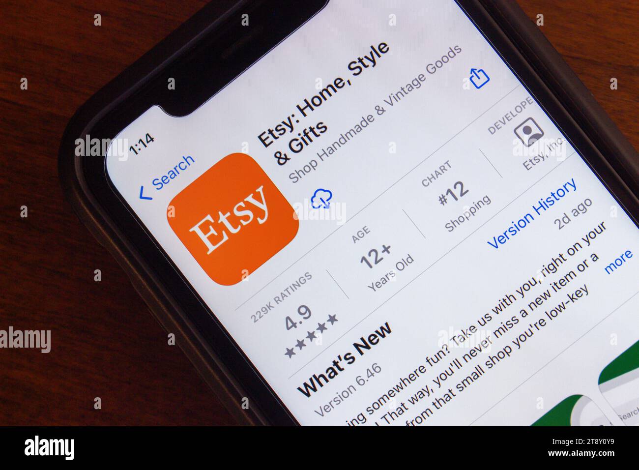 Etsy app seen in App Store on iPhone screen. Etsy, Inc. is an US e-commerce company specialized ...