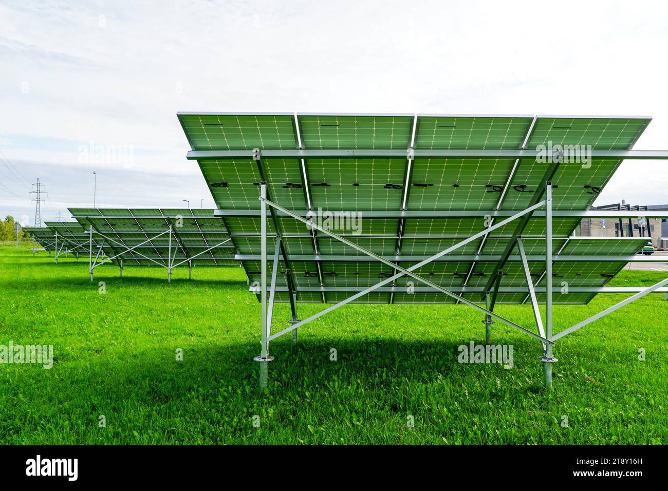 Installation of solar panels on metal frames in a green meadow ...
