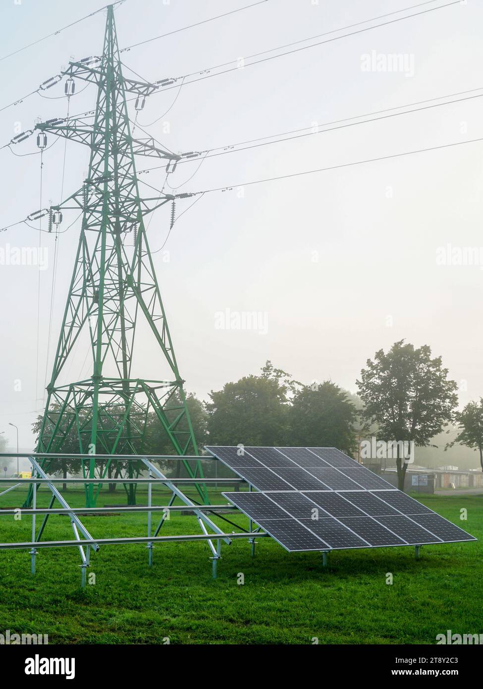 Installation of solar panels on metal frames in a green meadow near ...
