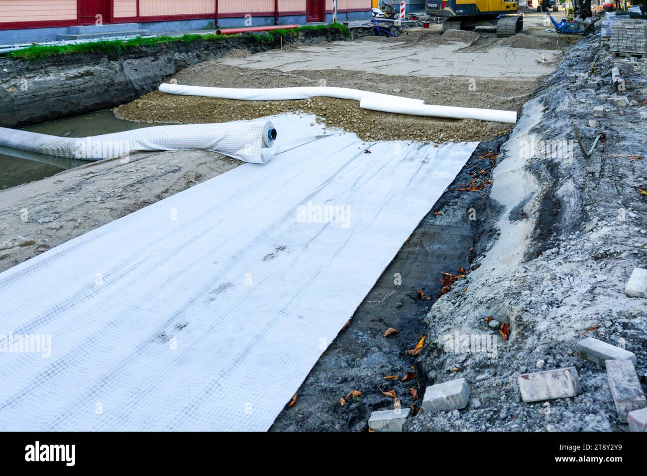 Use of geotextile fabric rolls for drainage and separation of base ...