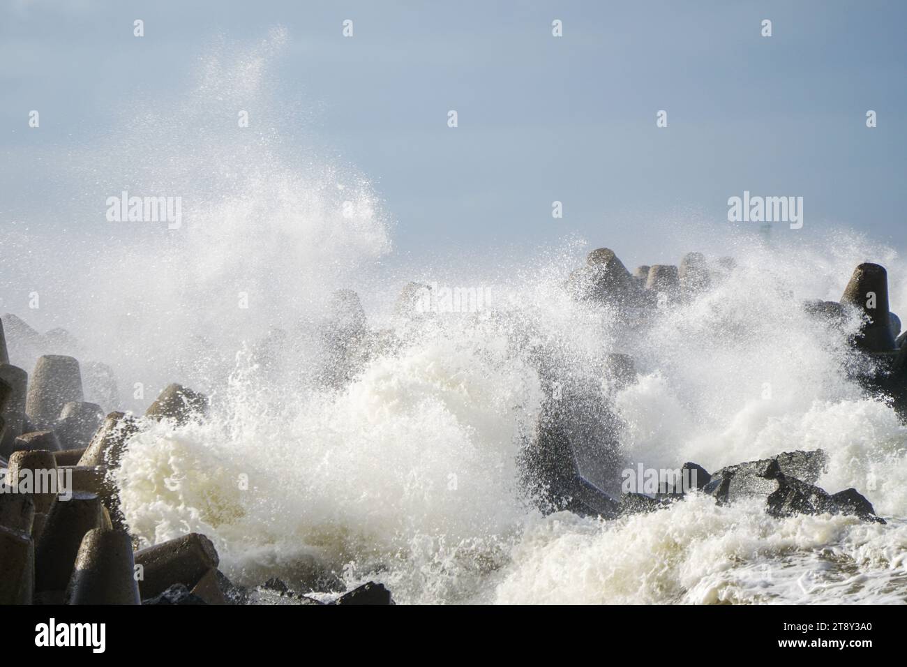 Storm at sea, high waves crashing against the concrete breakwaters of ...