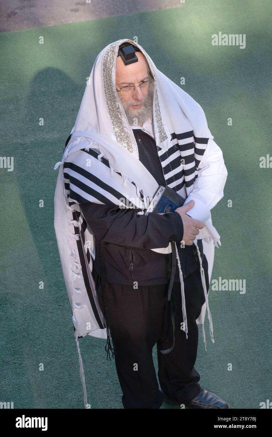An orthodox Jewish man wearing a prayer shawl & phylacteries poses for ...