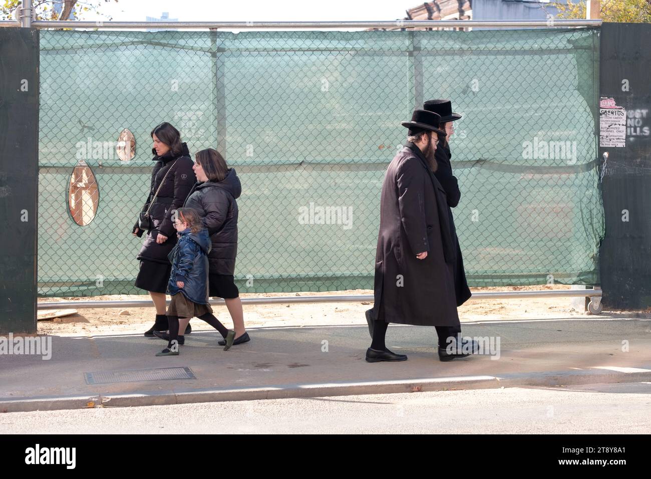 A Williamsburg, Brooklyn street scene. Men and women walk past a ...
