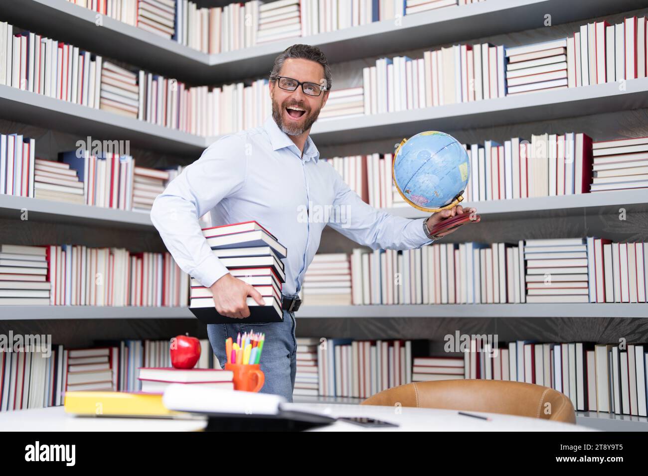 Portrait of teacher in library classroom. Handsome teacher in ...