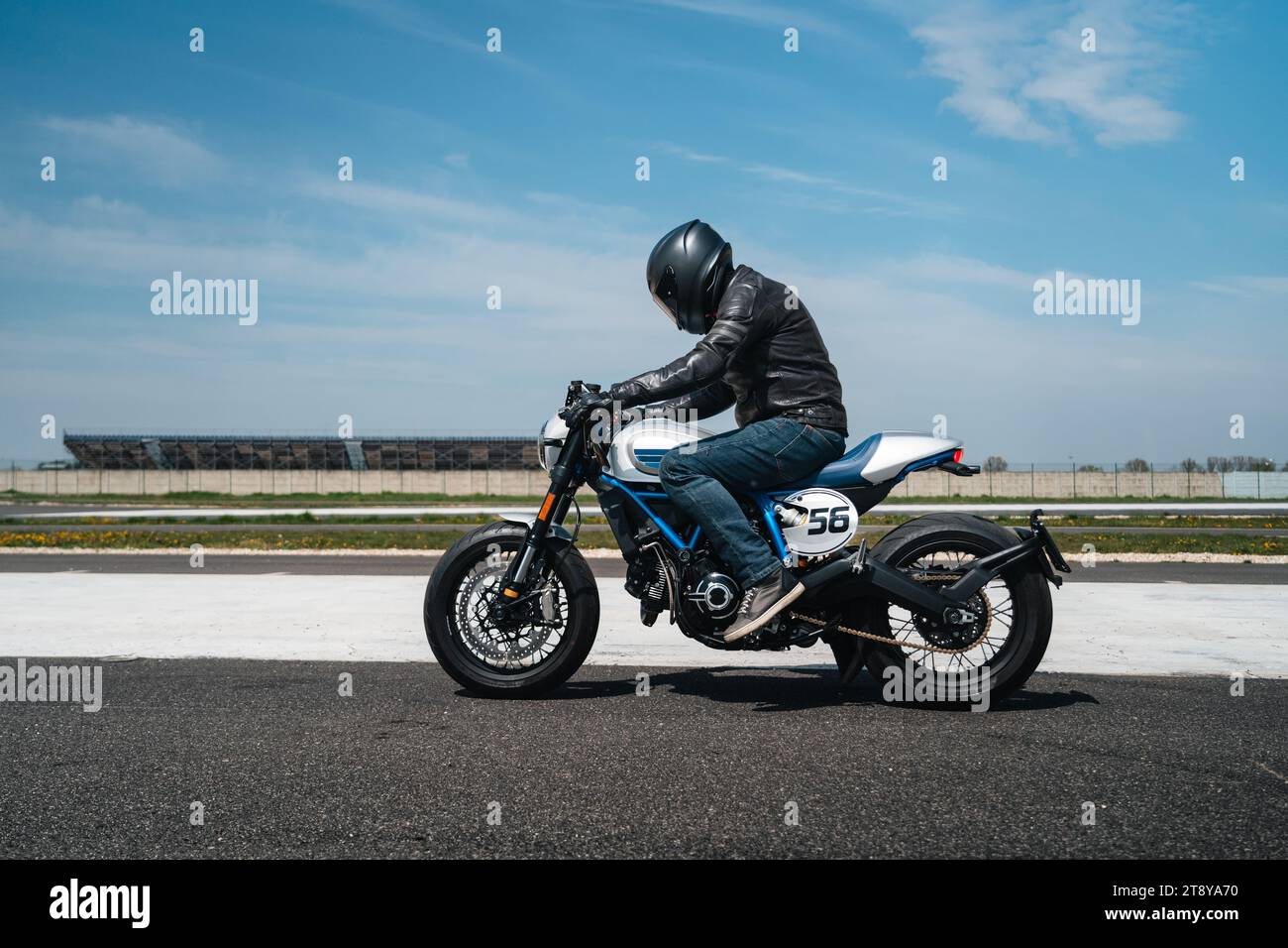 motorcycle rider sitting on his silver bike Stock Photo - Alamy