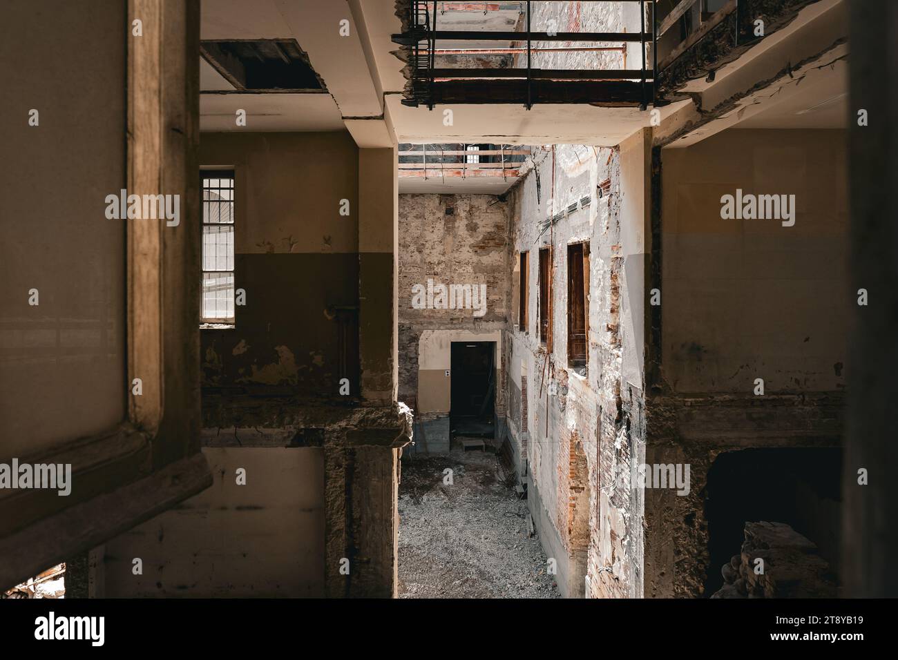 Abandoned, damaged interior building with falling apart brick walls and ...