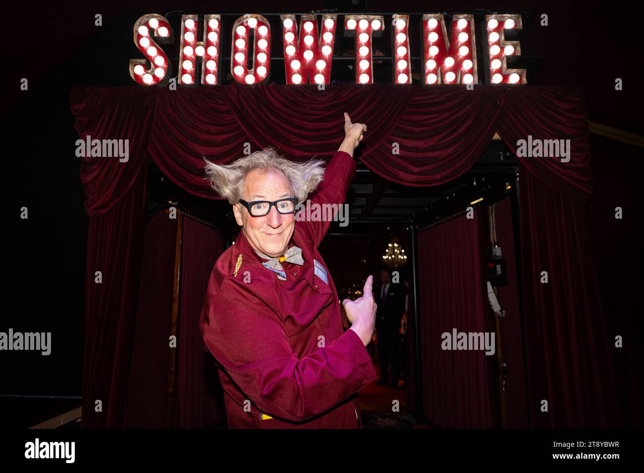 Munich, Germany. 21st Nov, 2023. Show assistant Daniello points to the ...