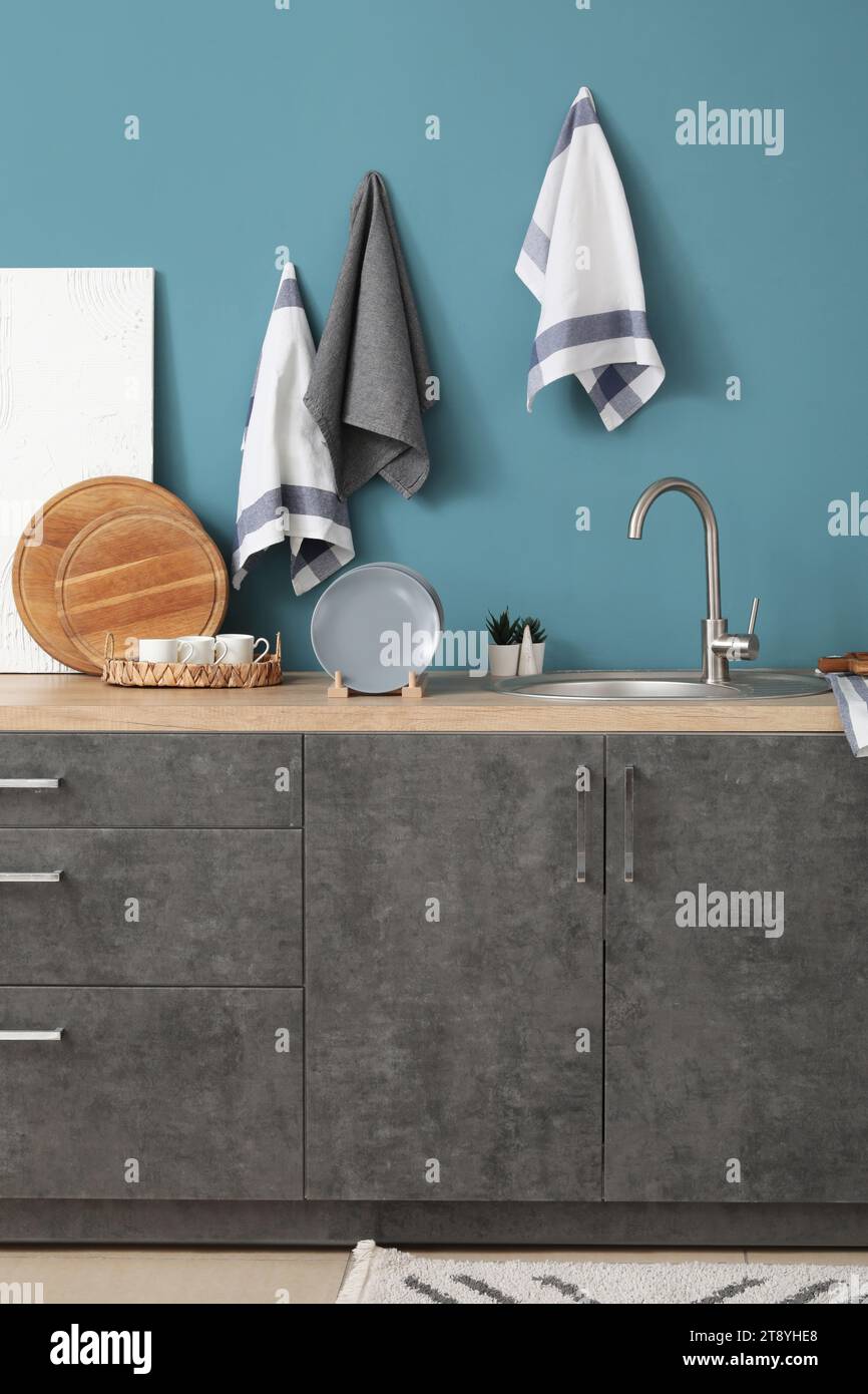 Grey kitchen counters with cutting boards, sink and utensils Stock ...