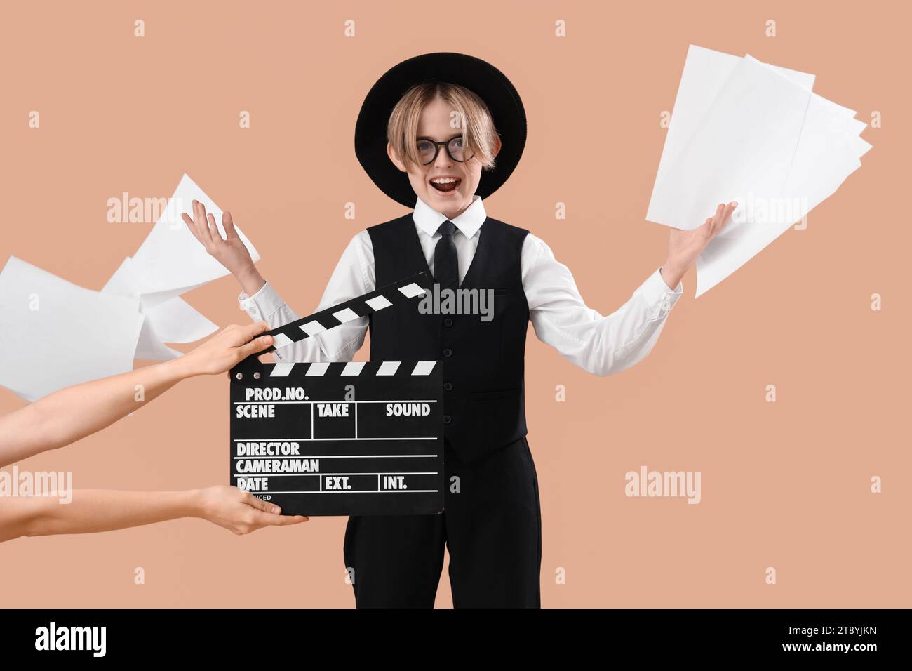 Little actor with film script on beige background Stock Photo - Alamy