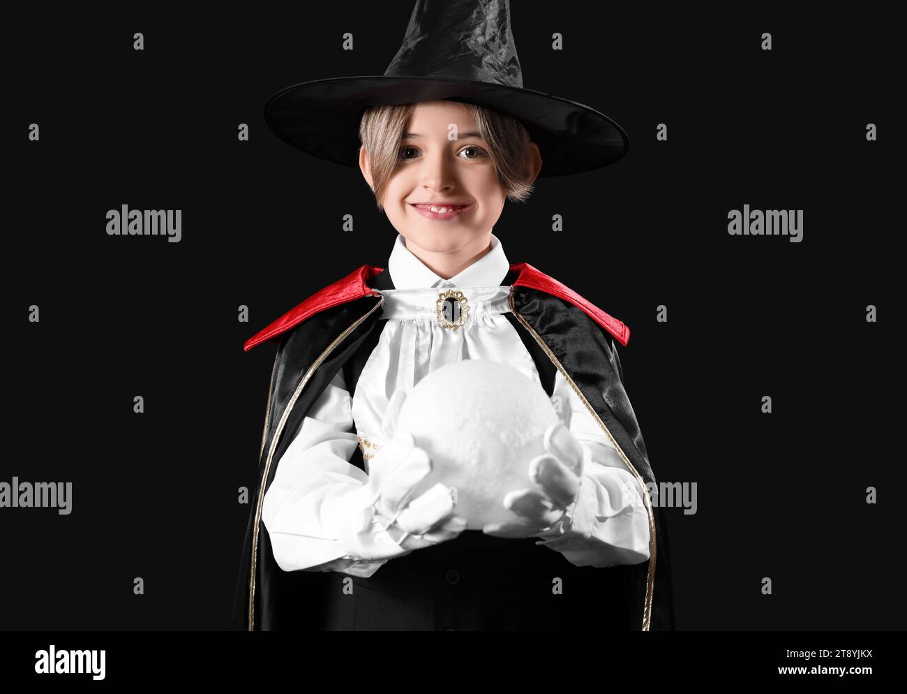 Little actor dressed as magician on dark background Stock Photo - Alamy
