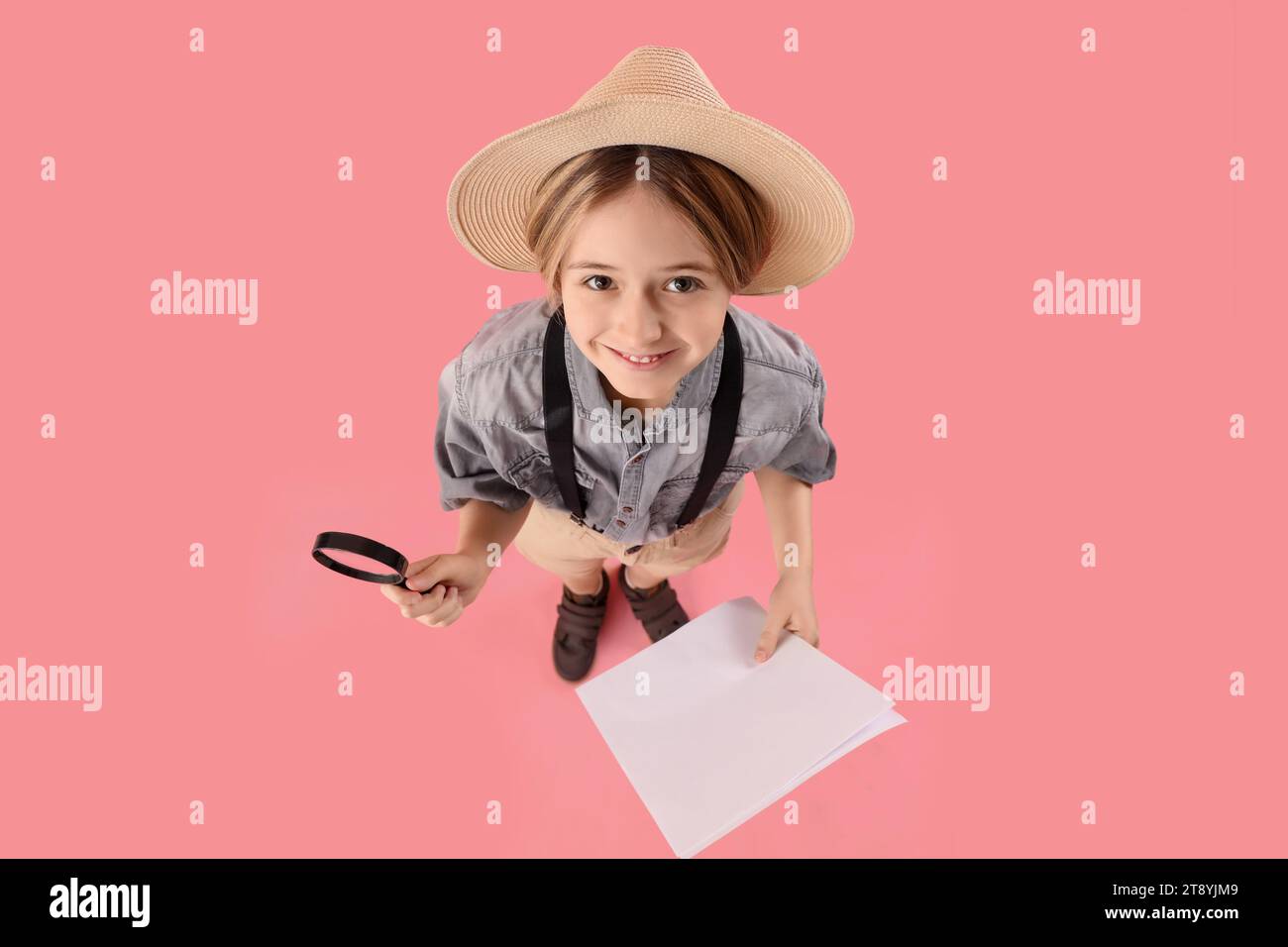 Little actor with magnifier and film script on pink background Stock ...