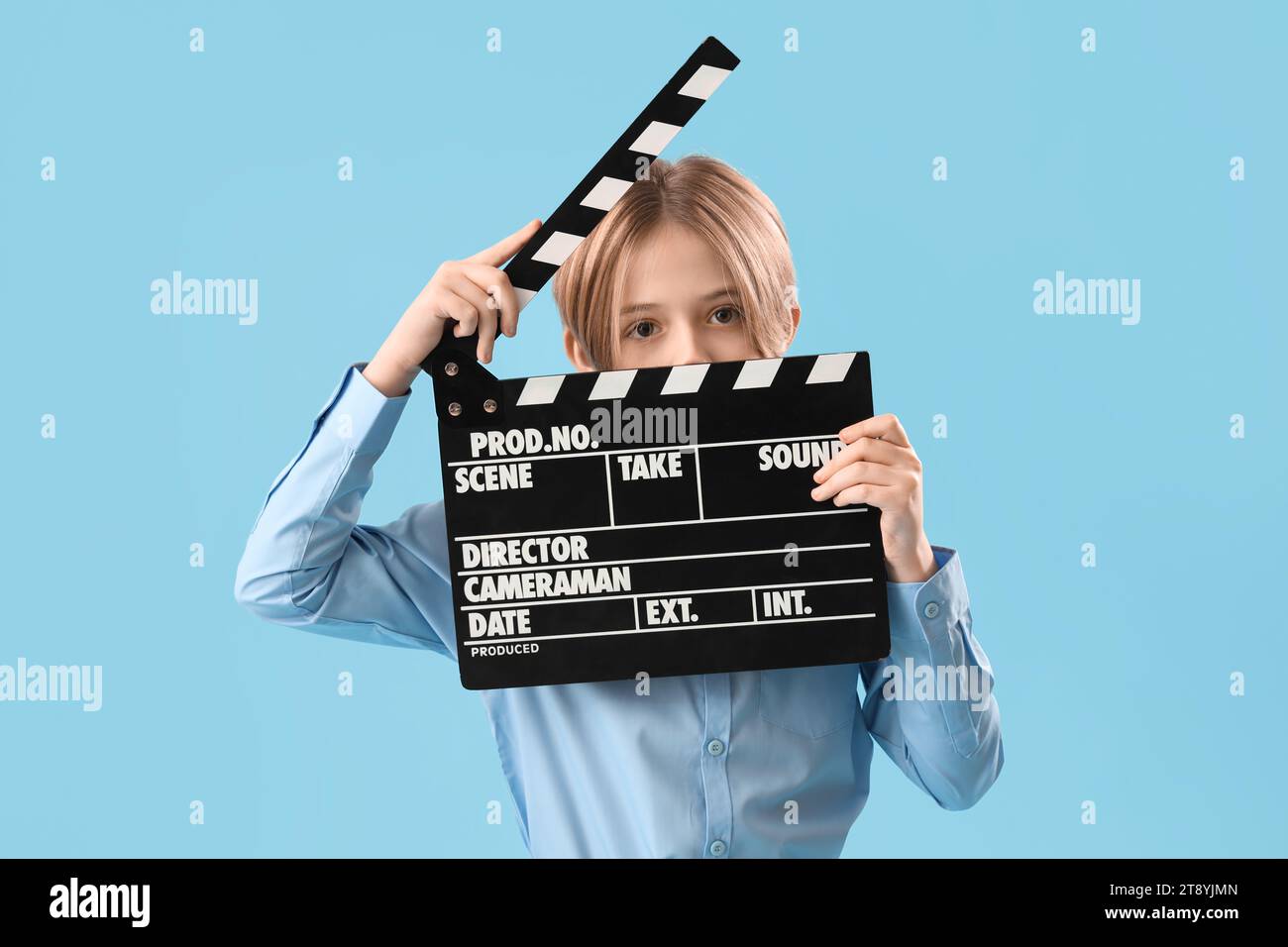 Little actor with movie clapper on blue background Stock Photo - Alamy