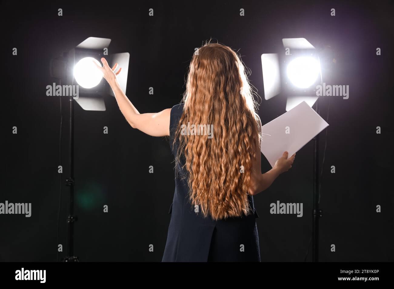 Beautiful actress with film script on dark background, back view Stock ...