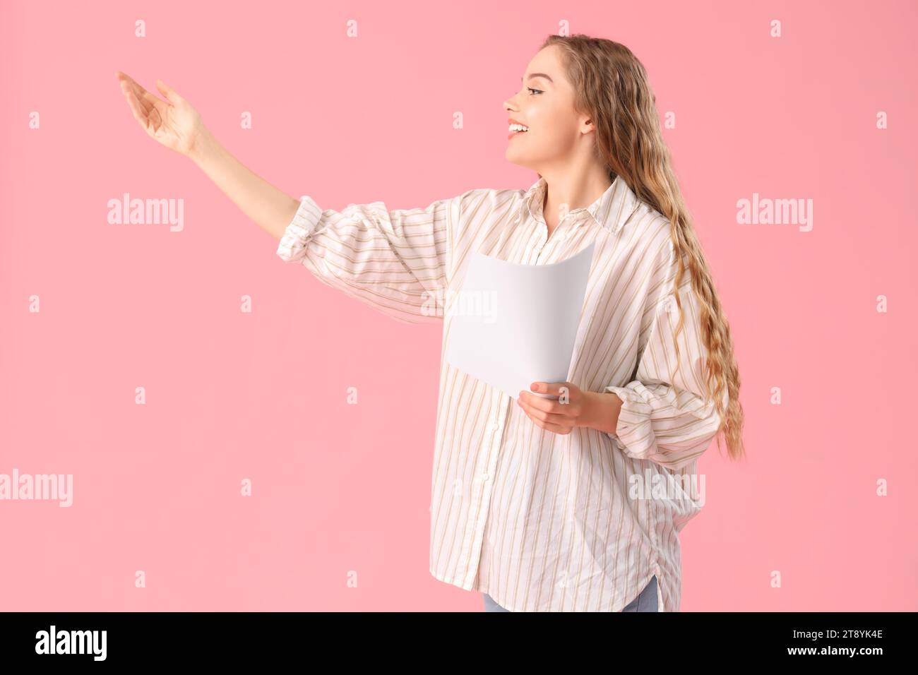 Beautiful actress with film script on pink background Stock Photo - Alamy