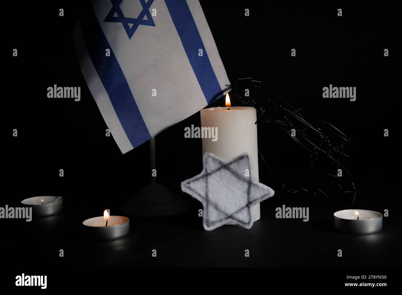 Burning candles with Jewish badge, barbed wire and flag of Israel on ...