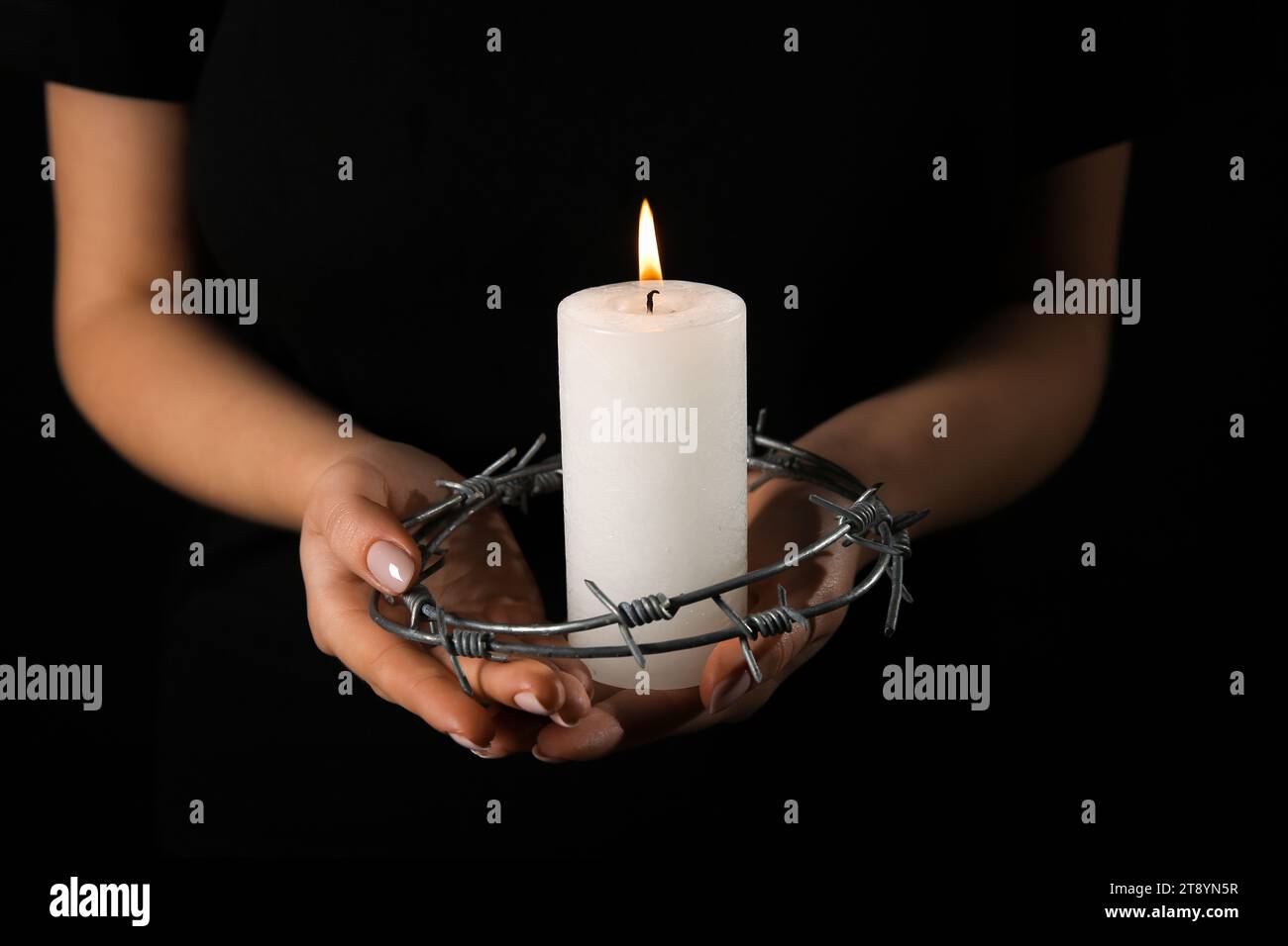 Jewish woman with burning candle and barbed wire on dark background ...