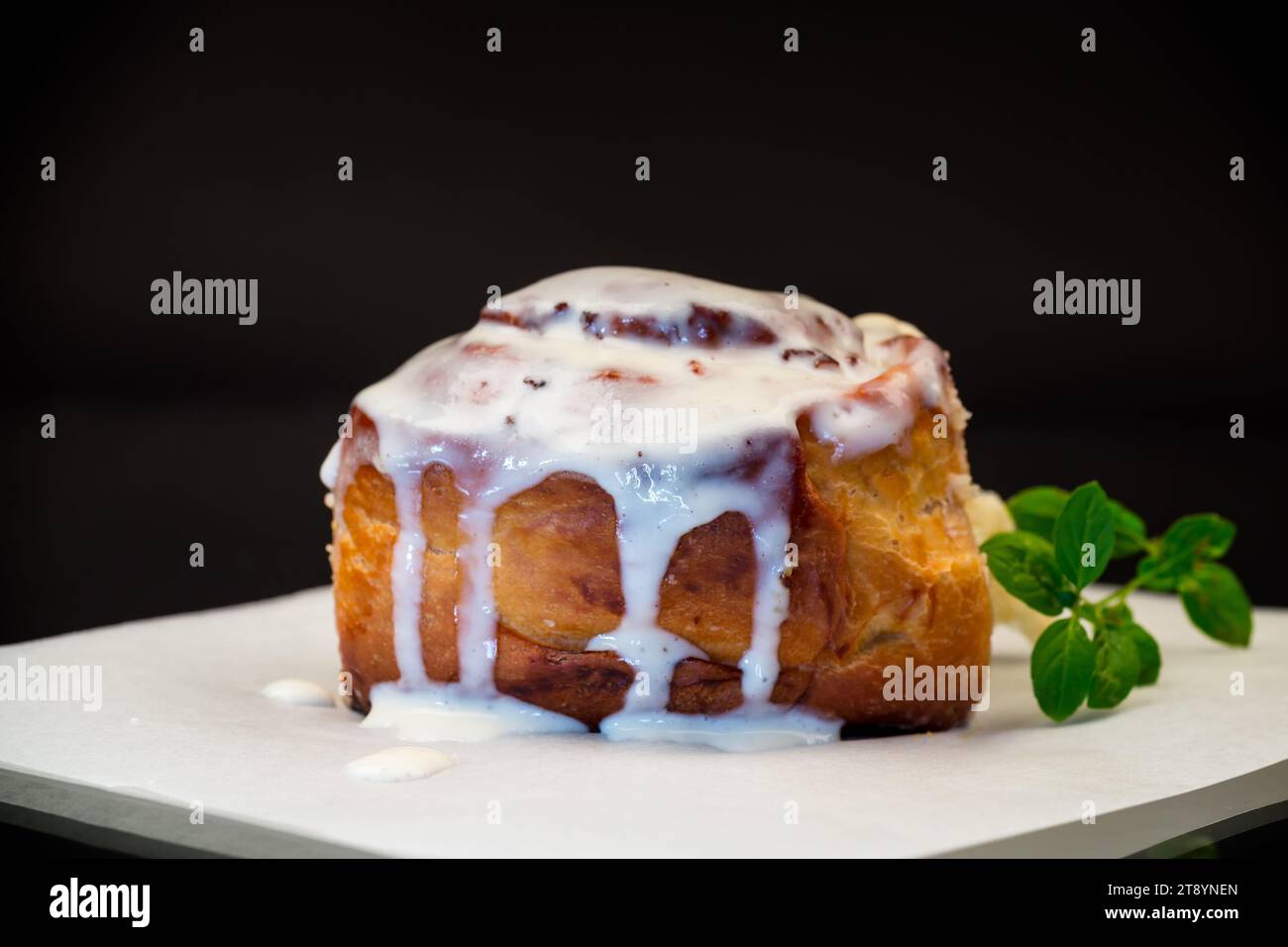 cooked baked sweet cinnabon with cream isolated on black background ...