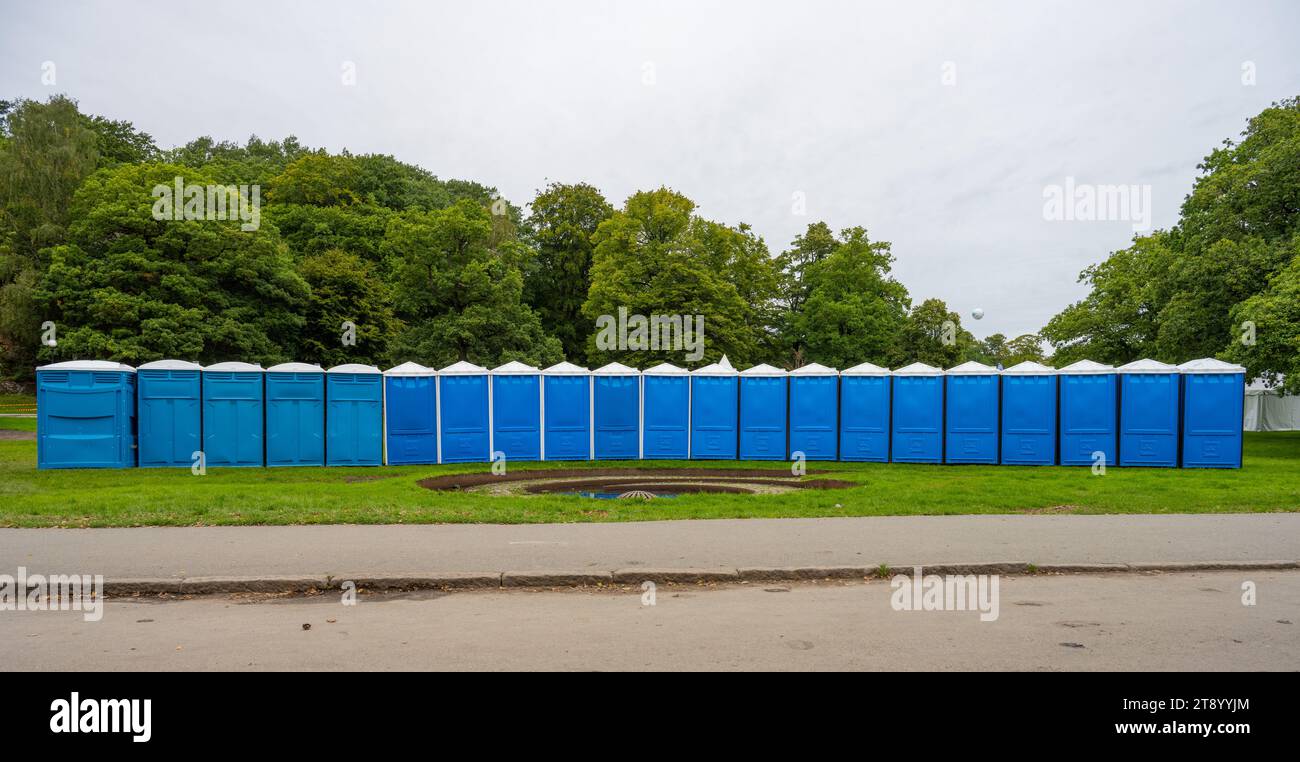 Long row of blue portable toilets Stock Photo - Alamy