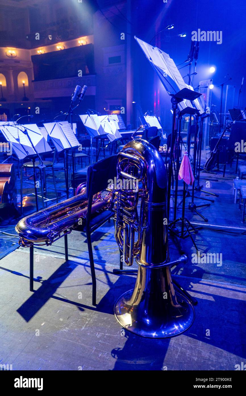 music stands with orchestral notes. Dim stage of the concert hall ...