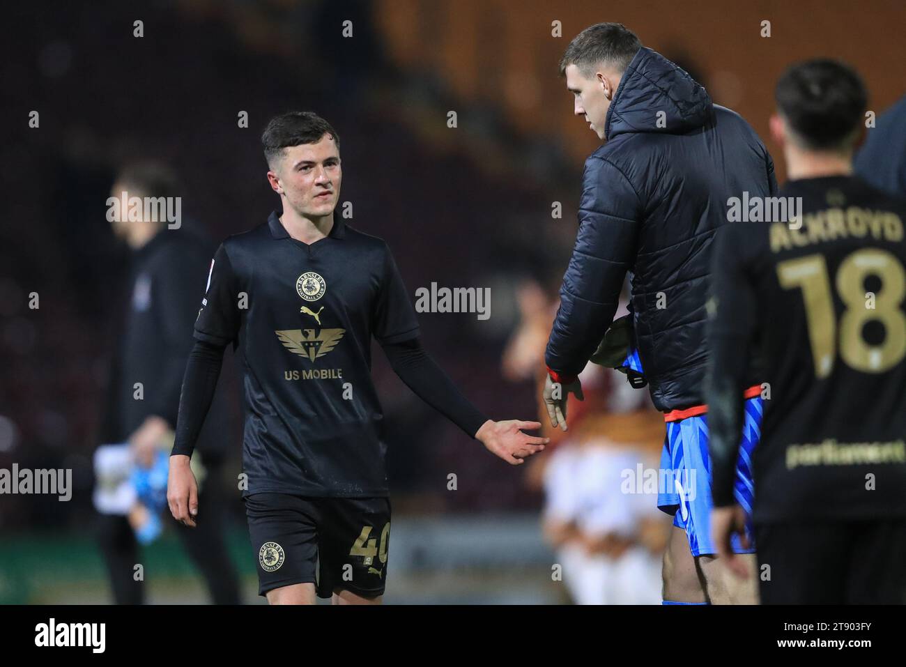 Aaron Atkinson #40 of Barnsley shakes hands with Kieren Flavell #50 of ...