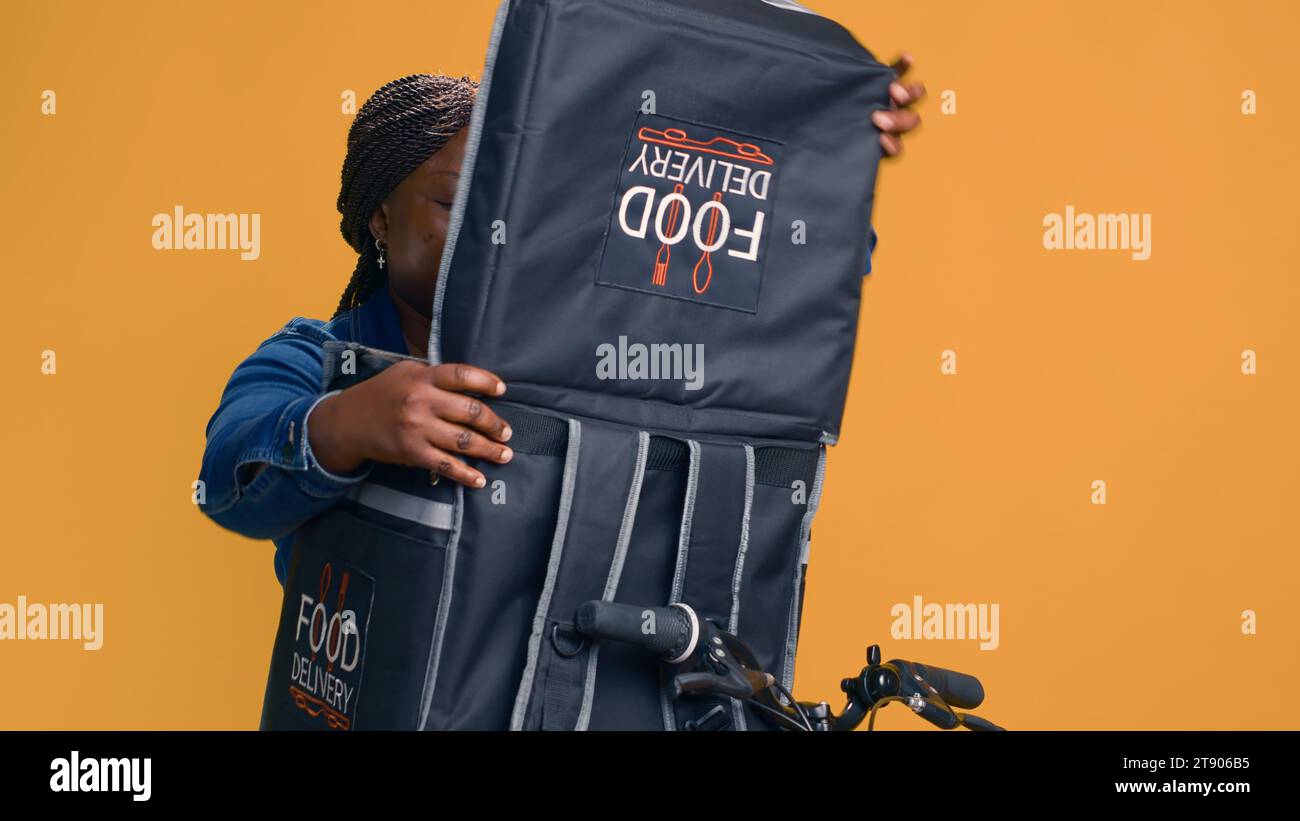 Timely delivery woman arriving with bicycle urban neighborhood and ...