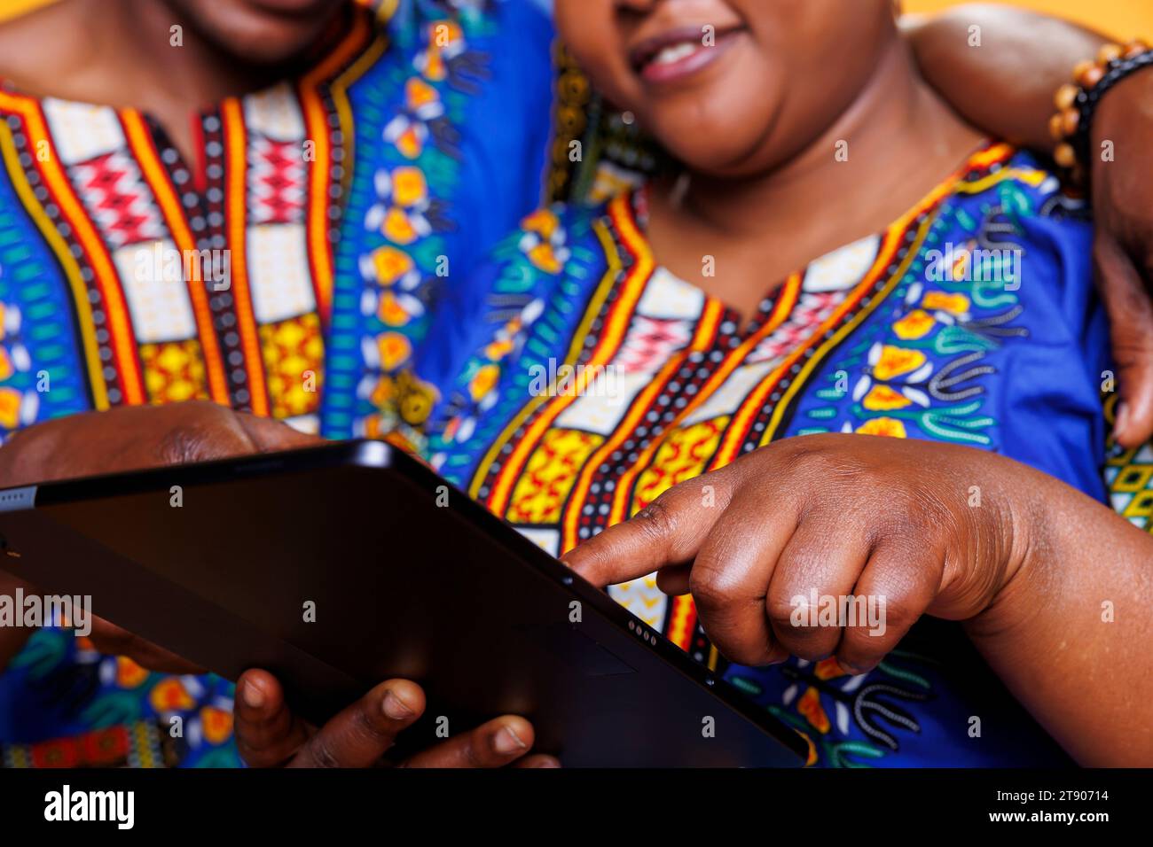 African american man and woman holding digital tablet and tapping with ...