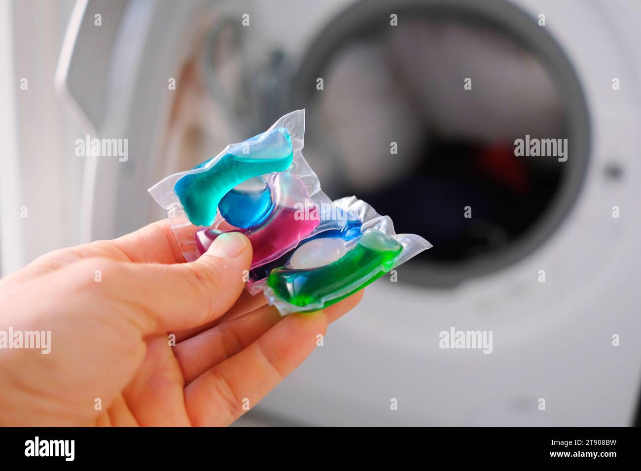 Washing machine detergent in pod form, with plastic that dissolves in ...