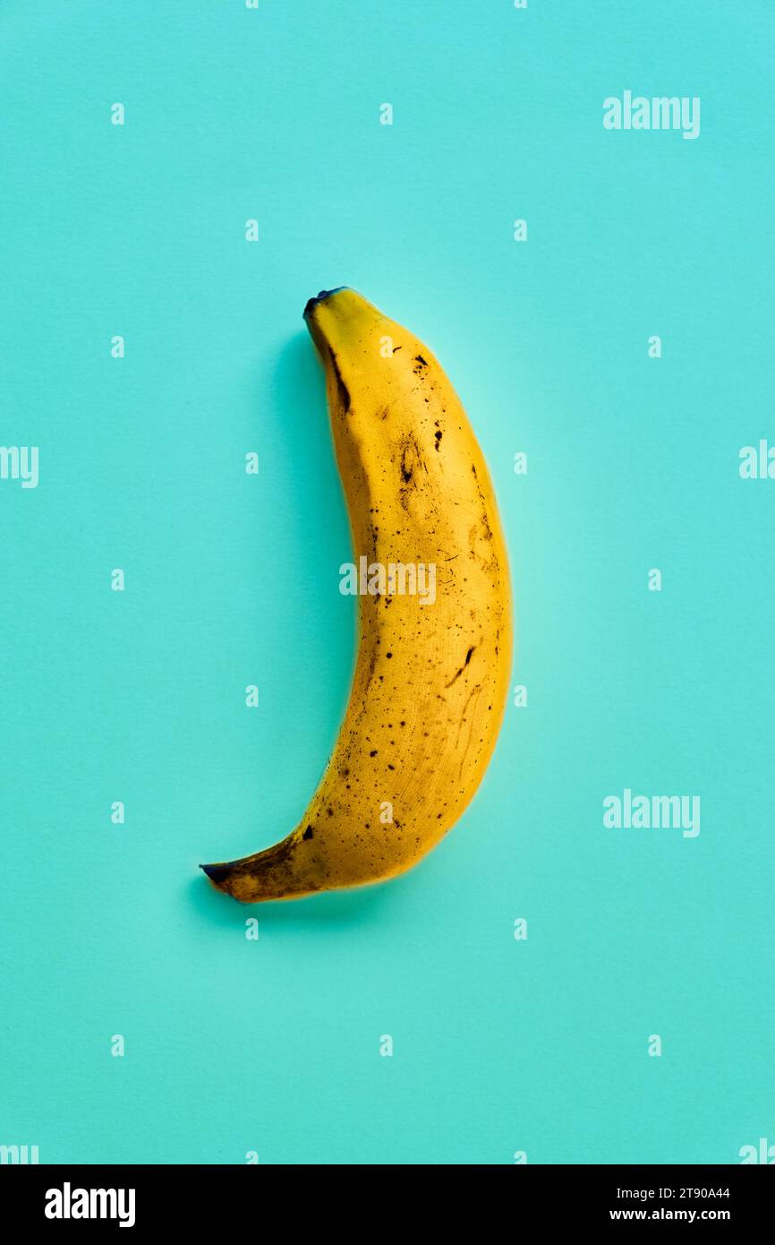 Banana on blue background Stock Photo - Alamy