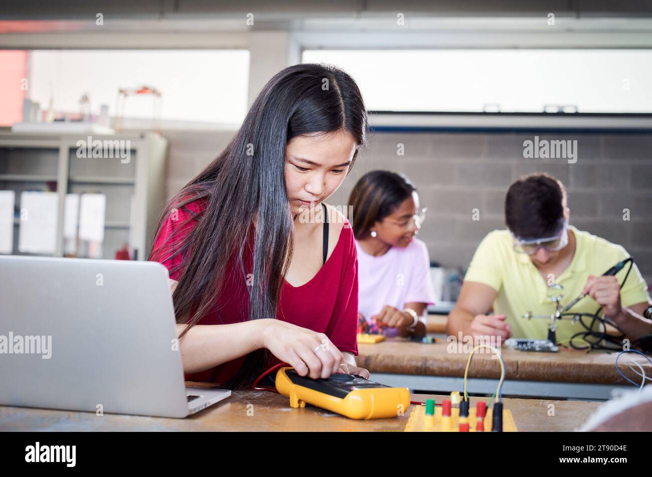 Portrait young Chinese student concentrating on electricity meter at ...
