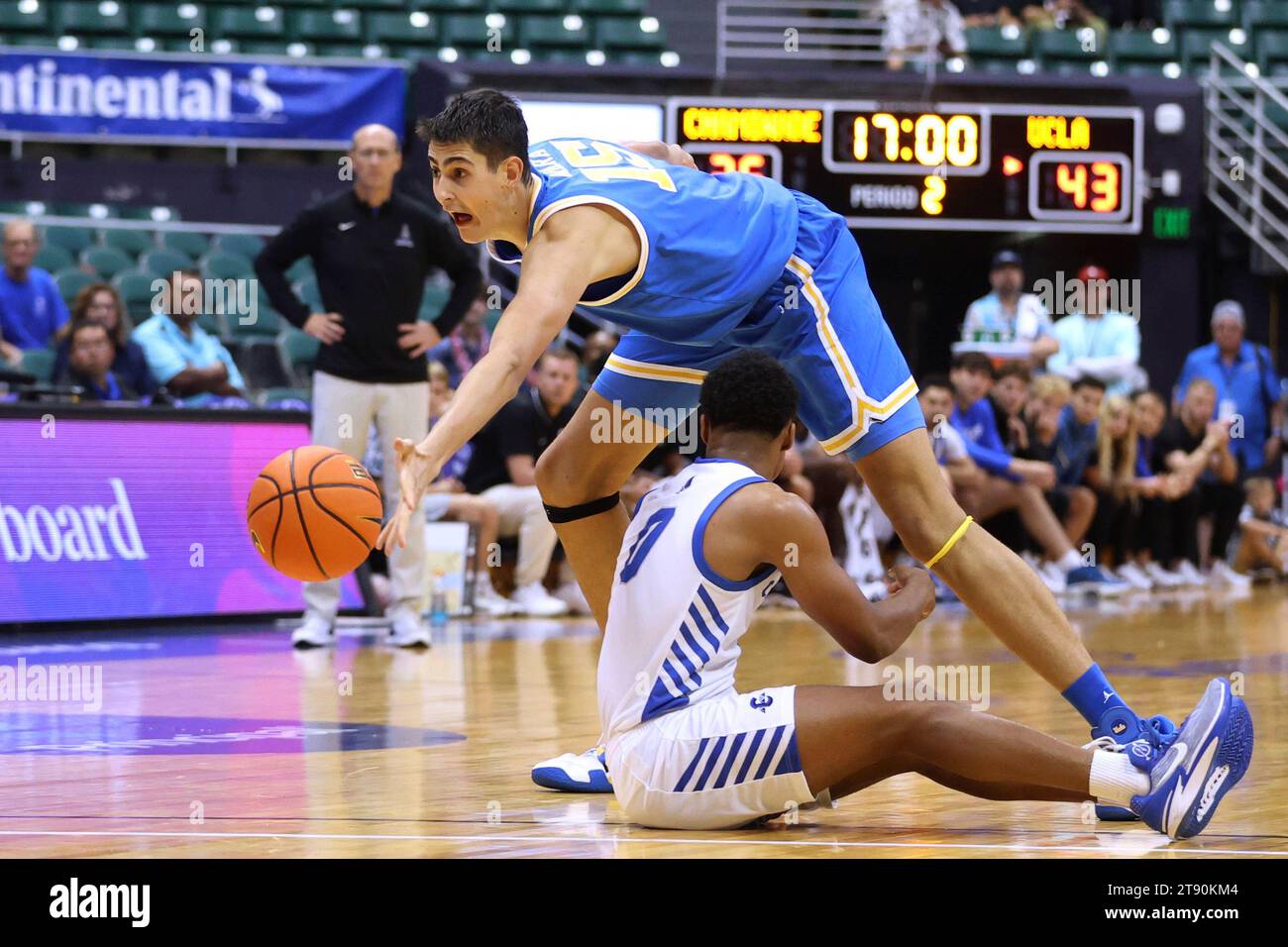 UCLA center Aday Mara (15) passes the ball away from Chaminade guard ...