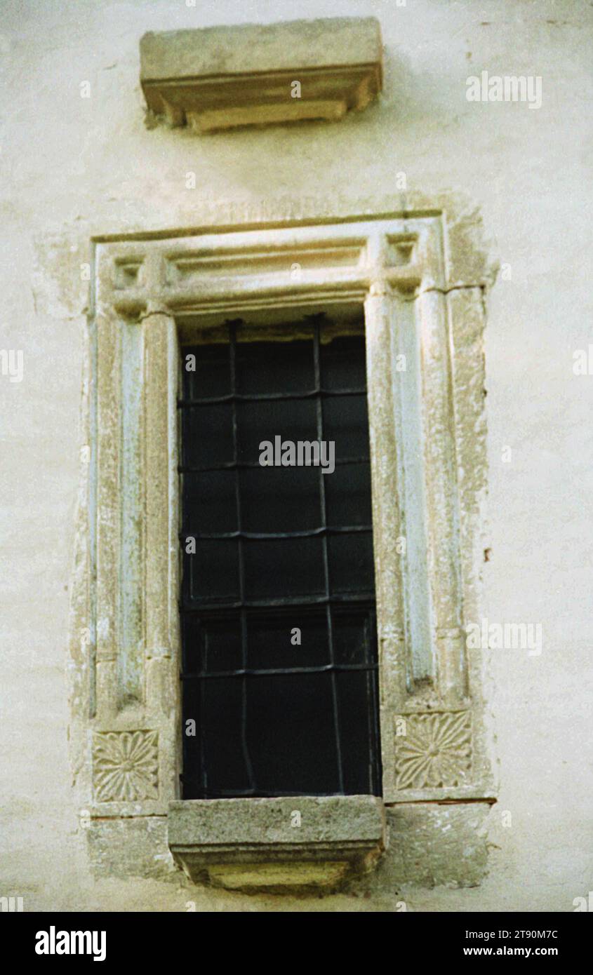 Vrancea County, Romania, approx. 1997. Window with ornate stone frame ...