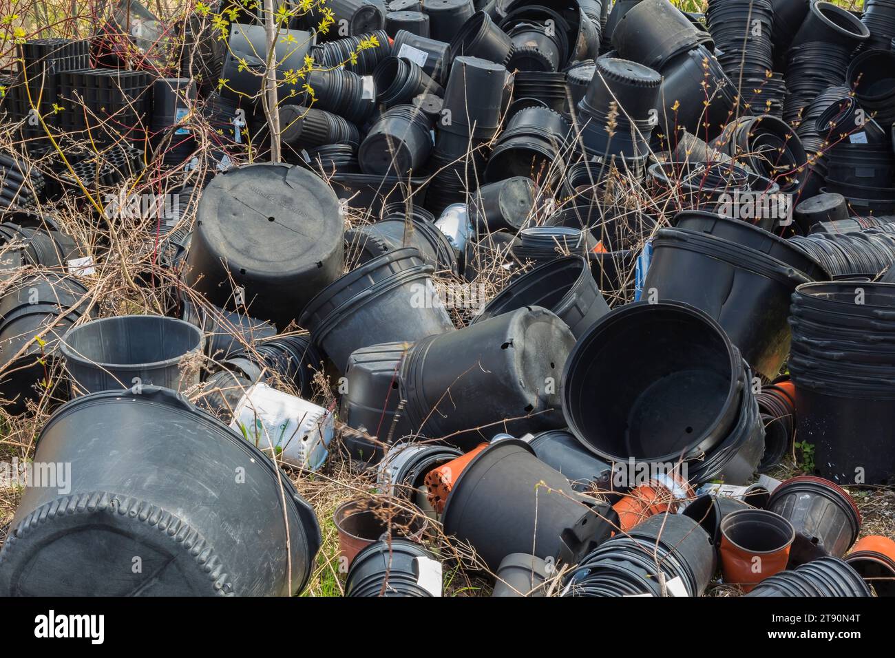 Pile of discarded assorted black plastic containers used for planting ...