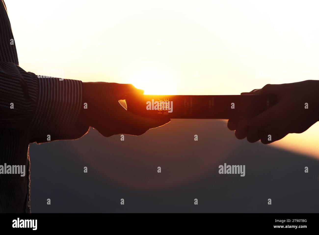 Christian hand presenting a holy Bible and church evangelism concept ...