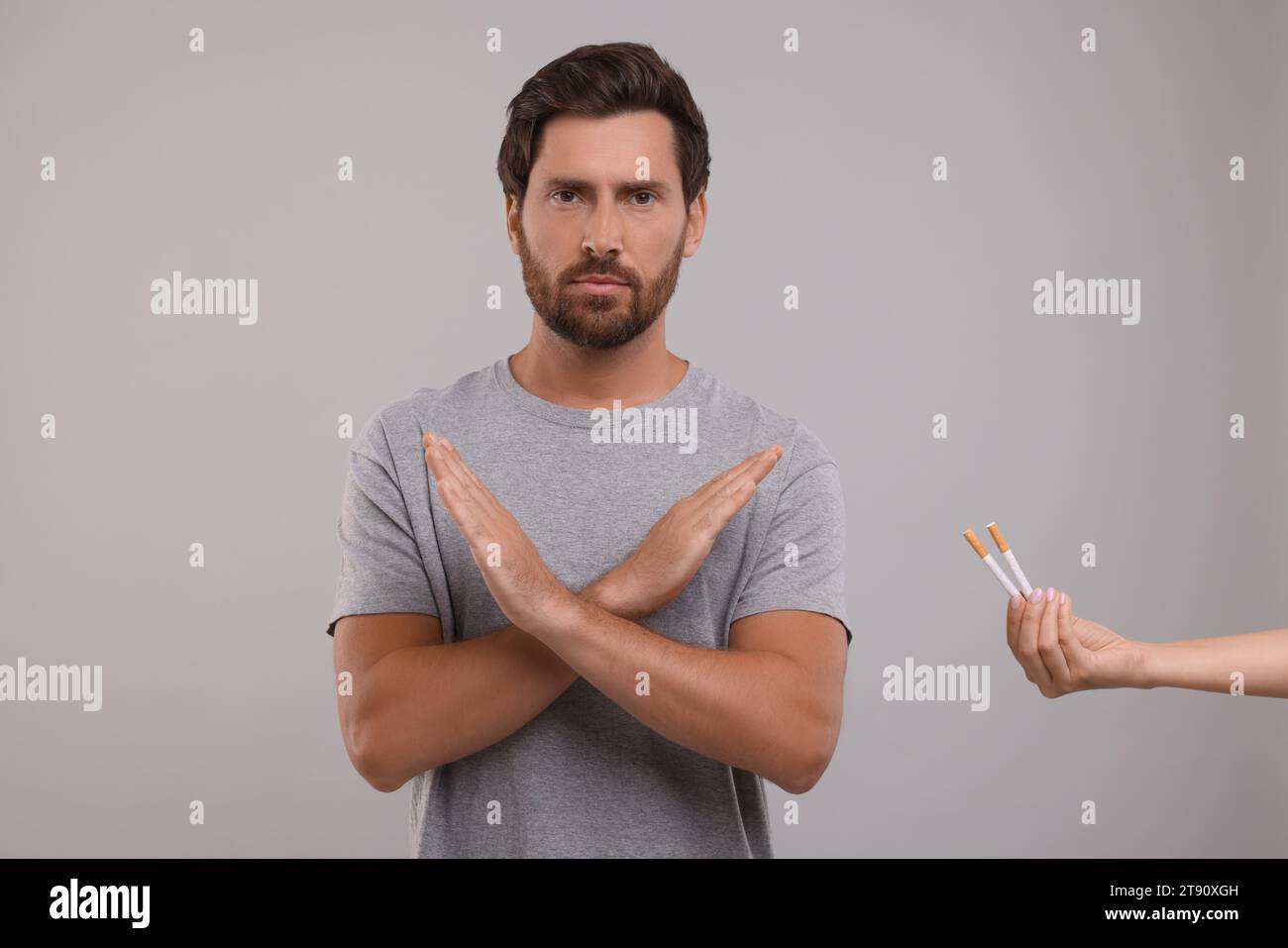 Stop smoking concept. Man refusing cigarettes on grey background Stock ...