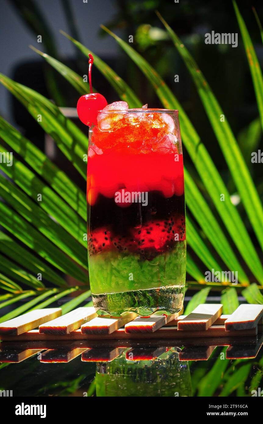 ice mixed with fruit filled with sticky rice tapai with a coconut leaf ...