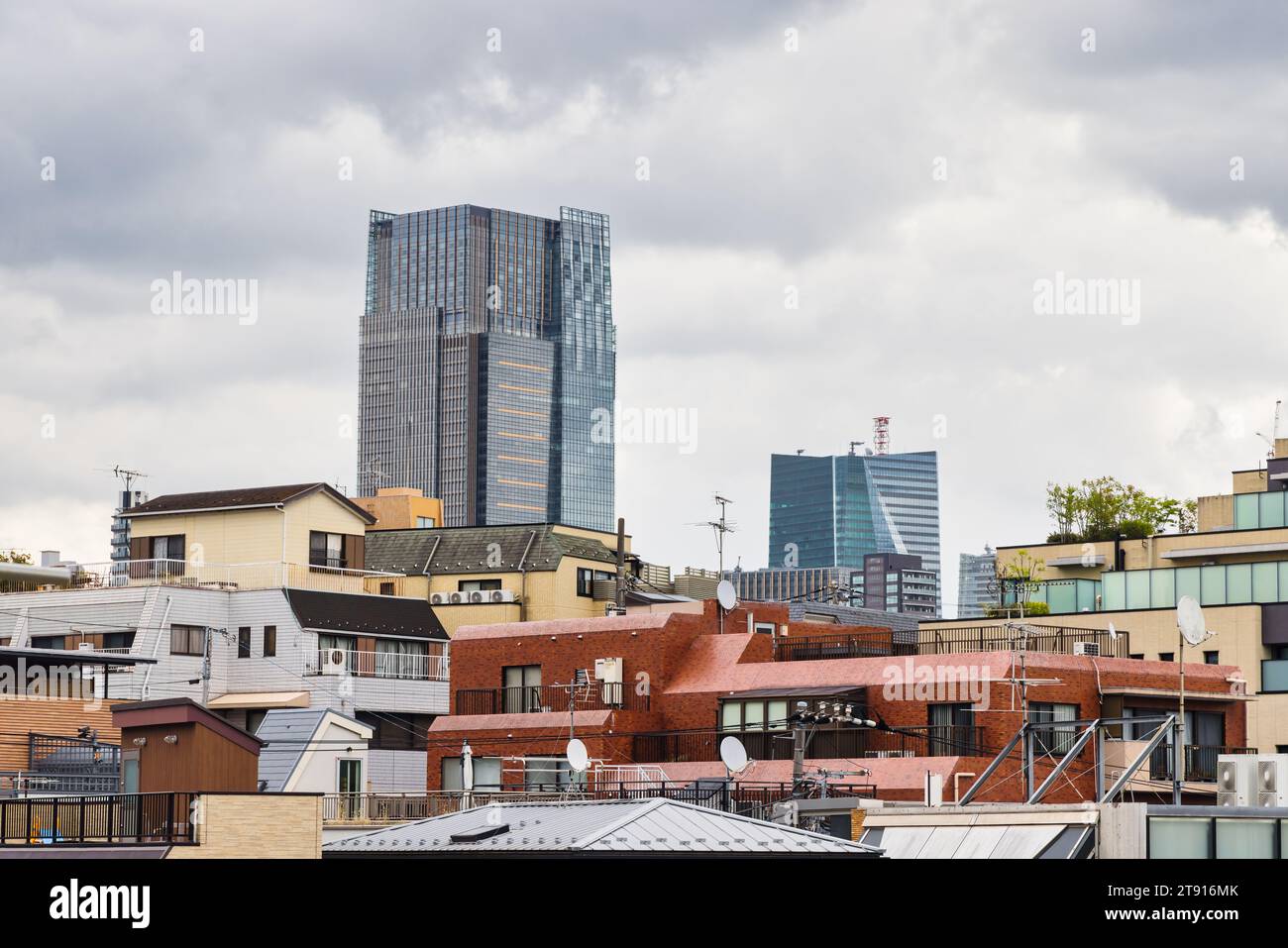 Typical view over house roofs with high-rise buildings in the ...