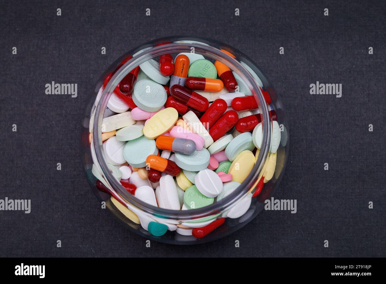 a pile of medicine in a transparent bowl. top view. too much medication ...