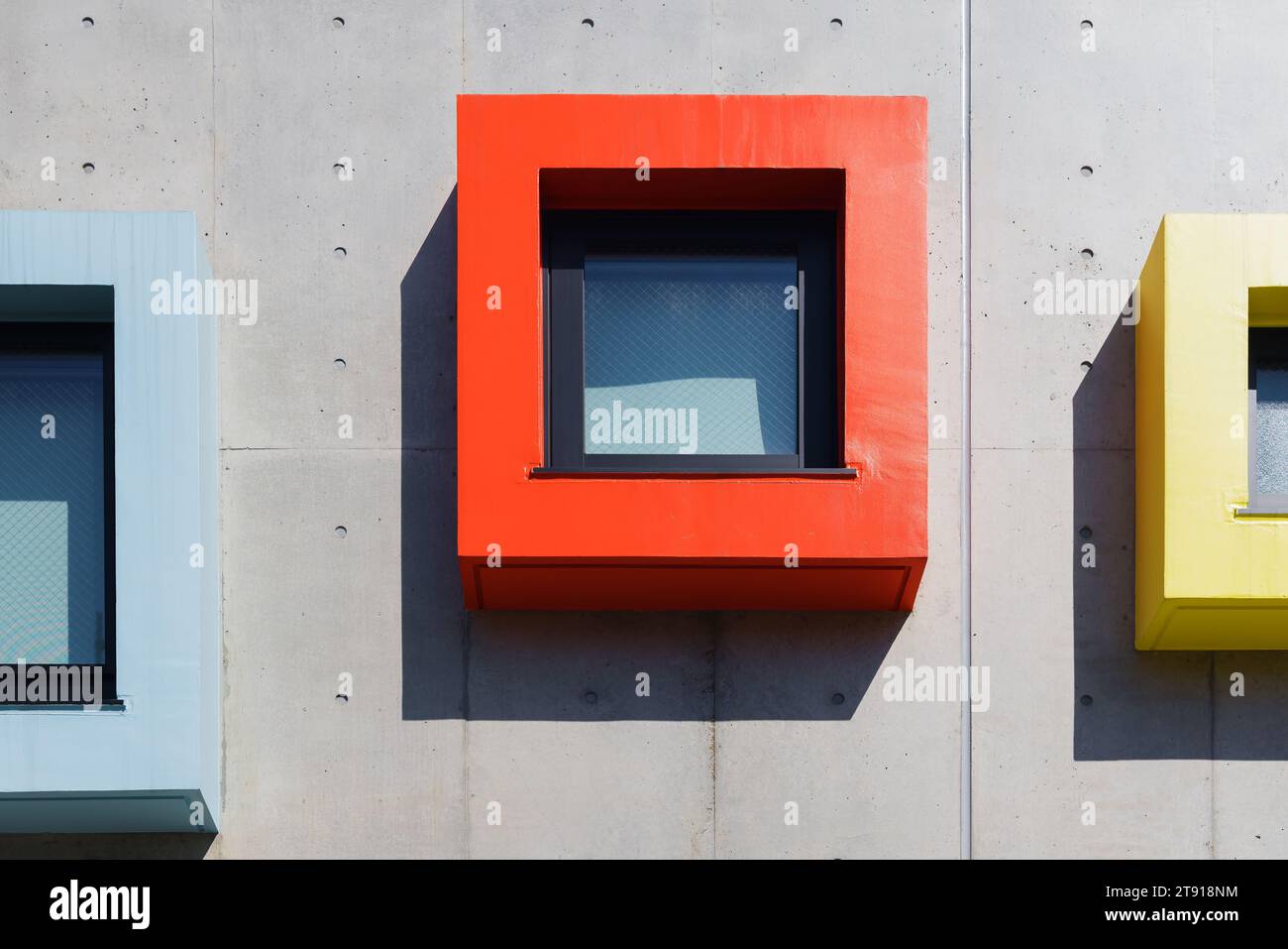 picture of uniquely framed windows with trendy colors on a concrete ...