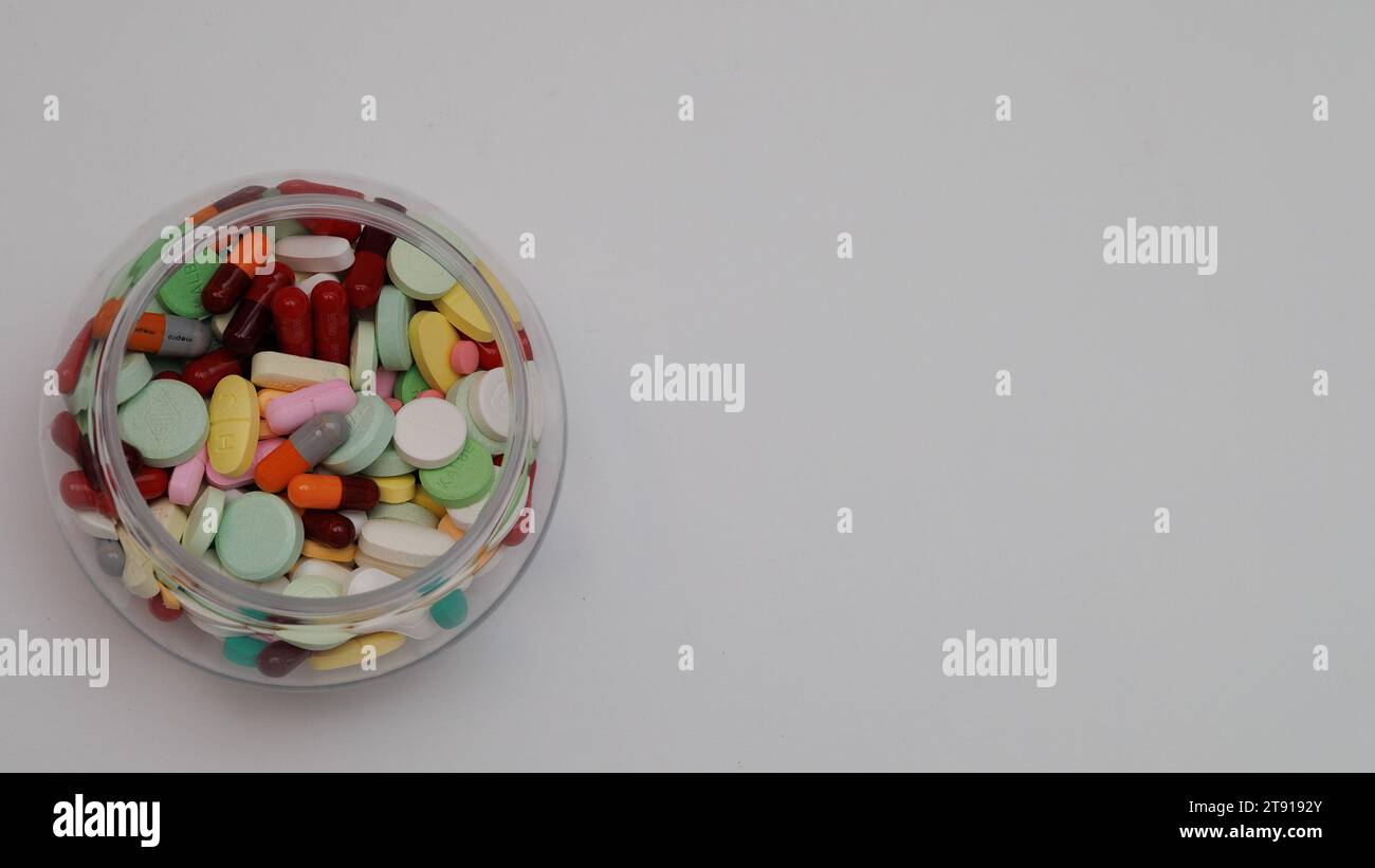 a pile of medicine in a transparent bowl. top view. too much medication ...