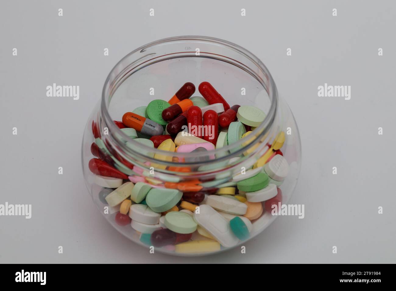 a pile of medicine in a transparent bowl. top view. too much medication ...