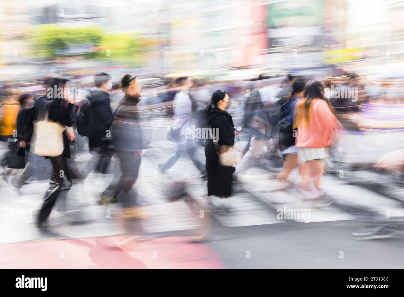 abstract photo of a crowd of people crossing a street in the big city ...