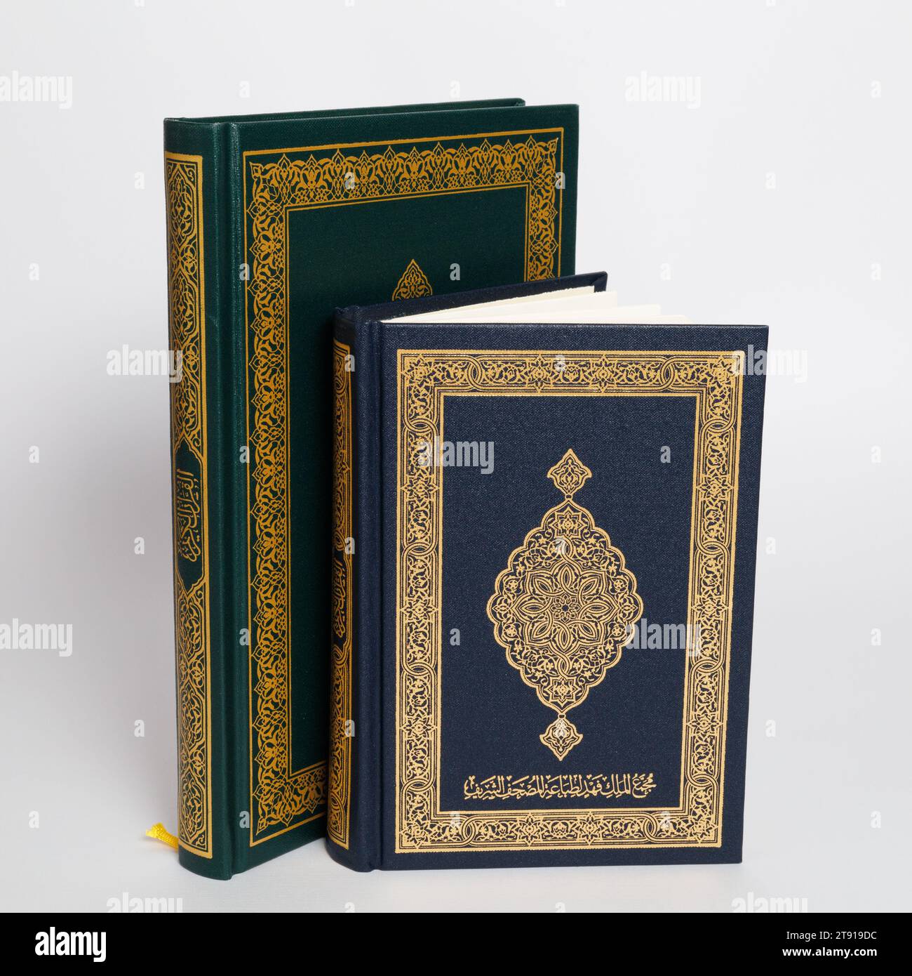 a set of holy quran books of various sizes isolated on a white ...