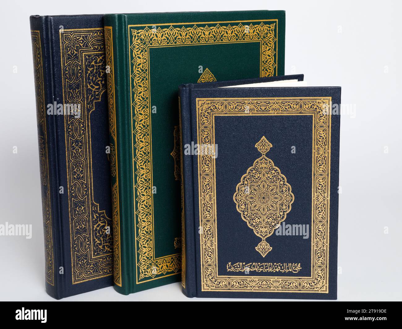 a set of holy quran books of various sizes isolated on a white ...