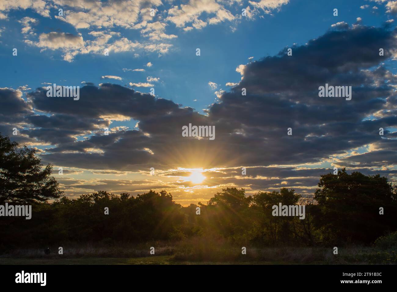 Sunrise in clouds with sun rays Stock Photo - Alamy