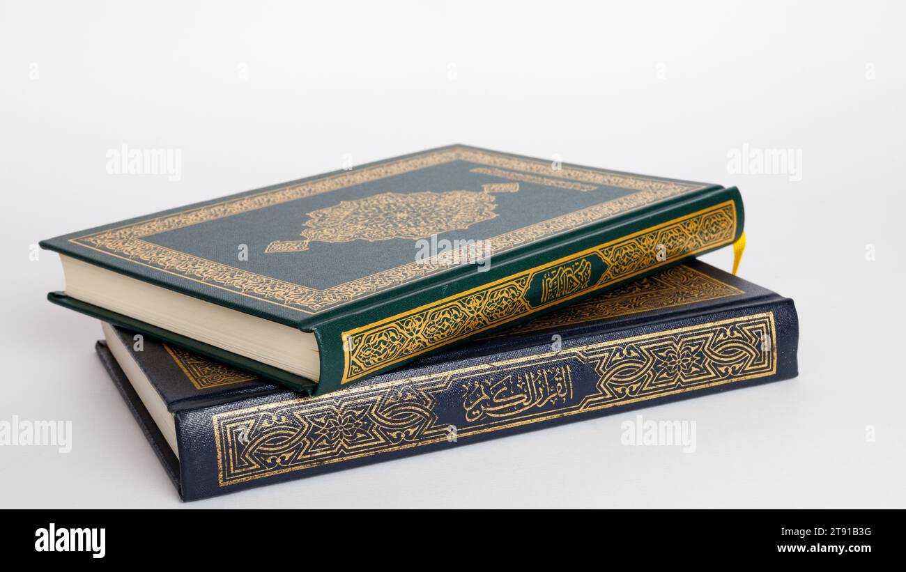 a set of holy quran books of various sizes isolated on a white ...