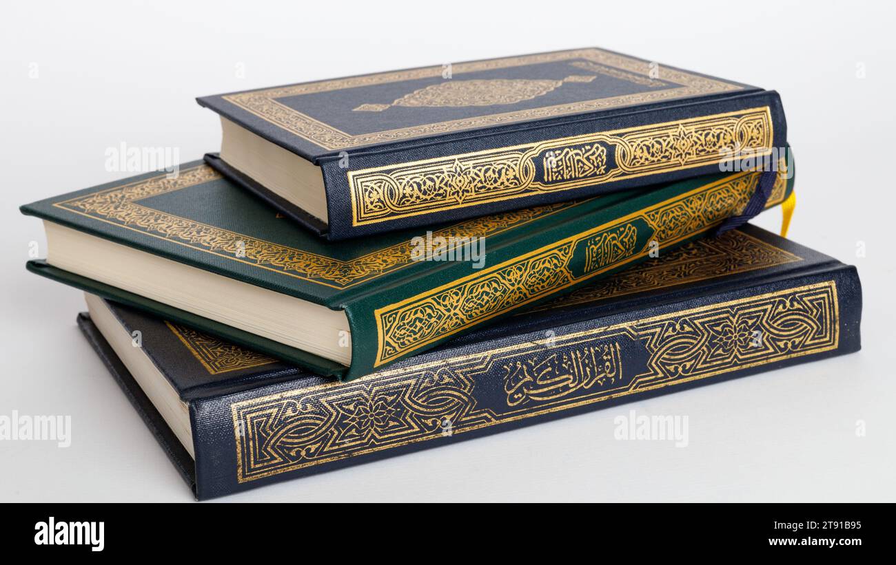 a set of holy quran books of various sizes isolated on a white ...